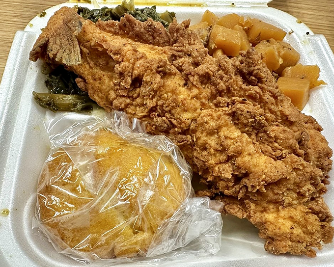 Fried catfish, candied yams, and greens - the holy trinity of soul food that makes you want to hug whoever's in the kitchen.