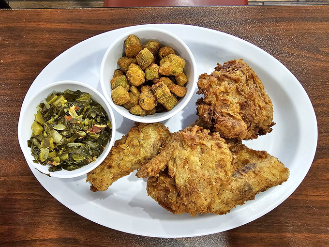 Southern fried chicken with sides that don't play second fiddle. Those collard greens have clearly been simmering with purpose and that cornbread isn't just an afterthought.