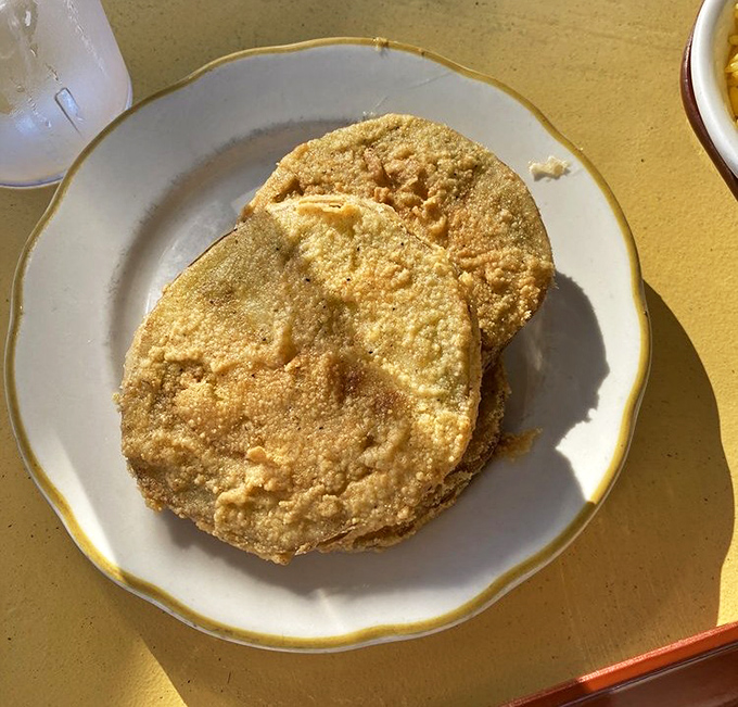 Fried green tomatoes with the perfect cornmeal crust—crispy on the outside, tangy and tender within. Southern cuisine's answer to the perfect appetizer.