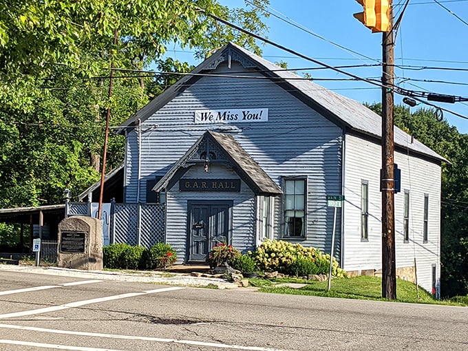 The G.A.R. Hall stands as a blue-gray sentinel of history with its "We Miss You!" sign&mdash;a building with stories to tell and music to share.