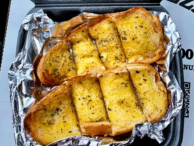 Golden garlic bread slices lined up like buttery soldiers ready to complement your Italian sub adventure.