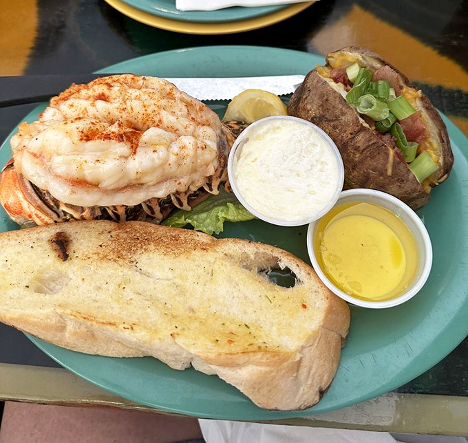 A lobster tail that practically high-fives your taste buds, accompanied by a baked potato that's been waiting all day to meet you. 