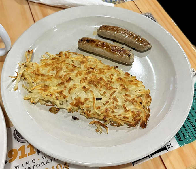 Crispy hash browns and sausage links &ndash; proof that sometimes the simplest breakfast combinations are culinary poetry on a plate.