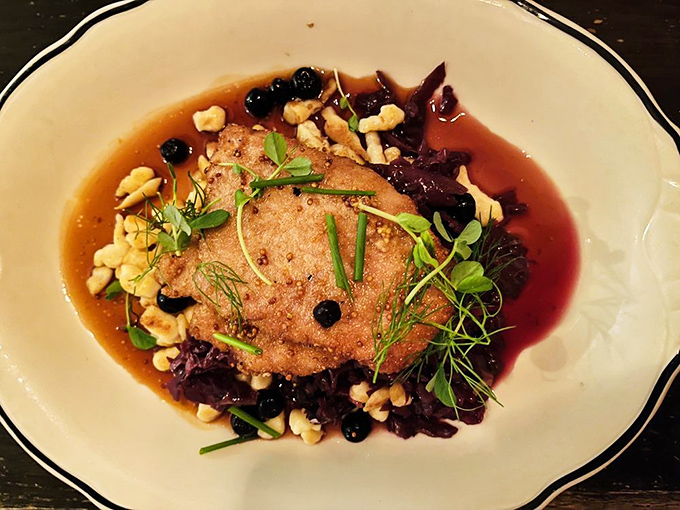 The Heritage Pork Schnitzel lounges in a pool of savory sauce like it knows it's the star of this culinary show.