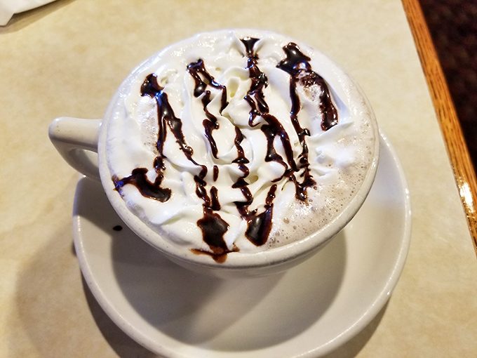 Hot chocolate that doesn't just warm your hands but your soul&mdash;topped with whipped cream and chocolate drizzle like an edible work of abstract art.