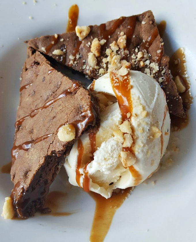 A chocolate dessert that makes you consider ordering a second one before you've finished the first. That caramel drizzle is performing magic tricks on vanilla ice cream.