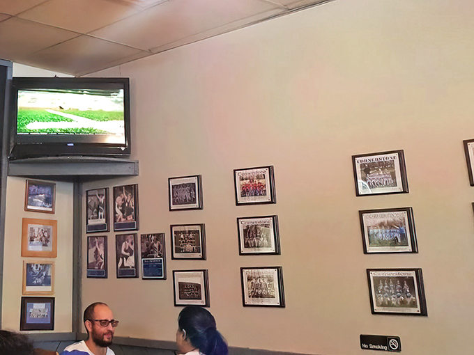 Sports memories line the walls, creating the perfect backdrop for creating new ones over plates that require both hands and several napkins.