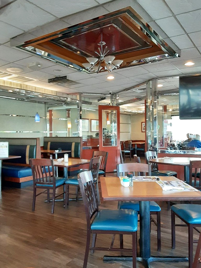 The dining room's mirrored ceiling panels and chrome accents create a space that feels both nostalgic and timeless, like comfort food for your eyes.