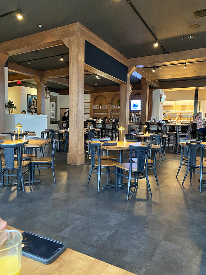 The restaurant's airy interior features substantial wooden columns and metal chairs that create an industrial-chic vibe without sacrificing comfort.