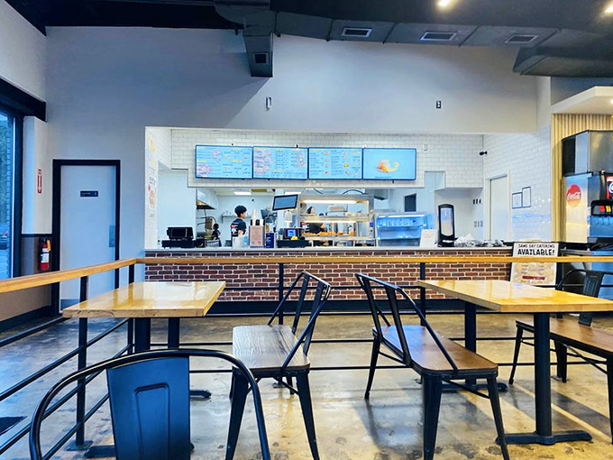 The ordering counter beckons with promises of crispy delights, while the open kitchen offers tantalizing glimpses of the magic happening behind the scenes.