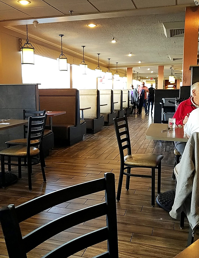 Booth seating where morning conversations flow as smoothly as the perfectly poured coffee refills.
