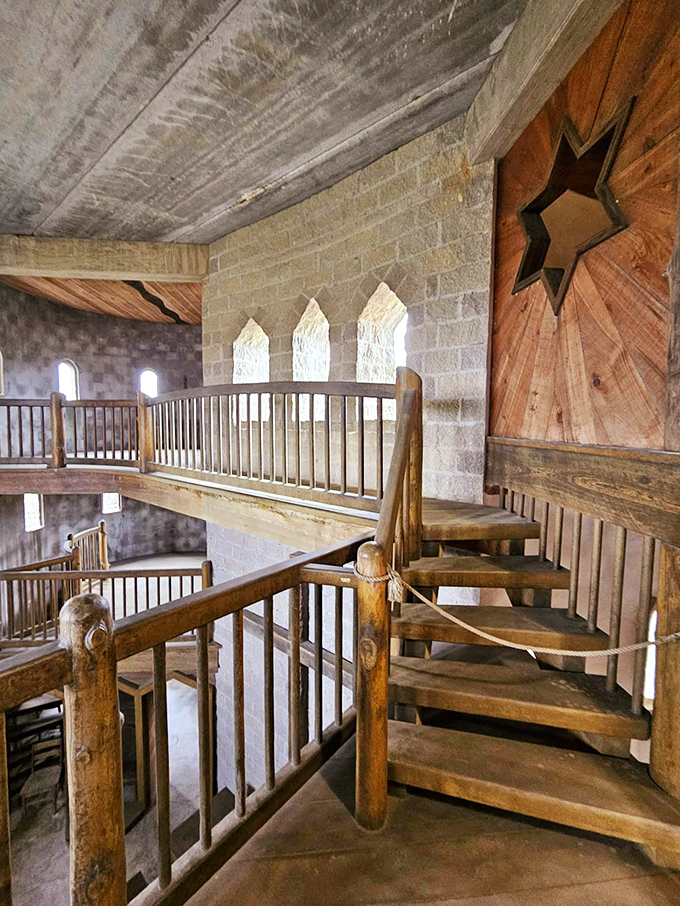 Wooden balconies and staircases add warmth to the stone interior, creating spaces that feel both ancient and surprisingly inviting.