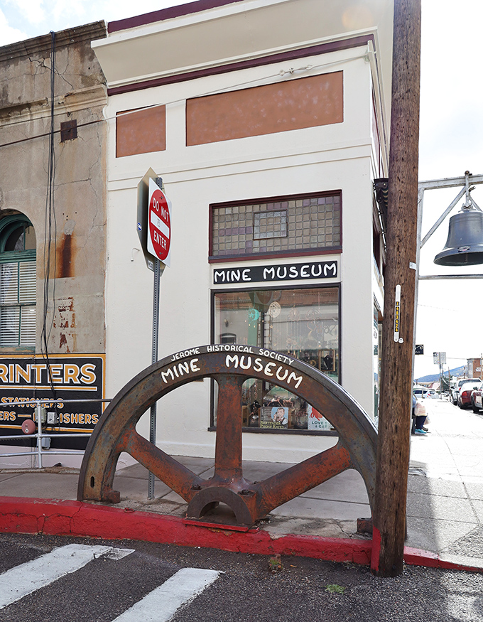 The Mine Museum's entrance wheel stands as a monumental reminder of the industry that built Jerome before artists and tourists saved it.