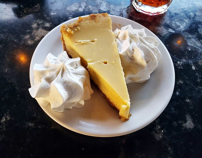 Key lime pie that captures Florida sunshine in every bite – tangy, sweet, and crowned with clouds of whipped cream.