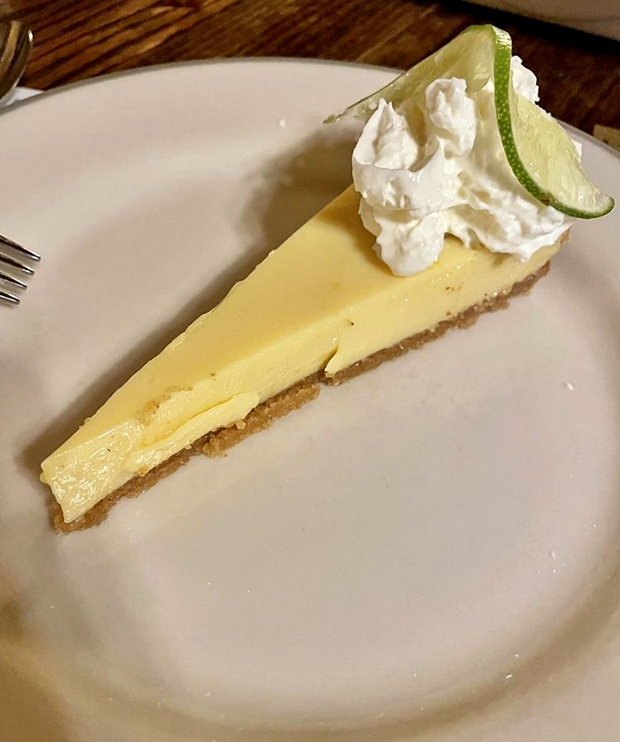 Key lime pie that strikes the perfect balance between tart and sweet, topped with a cloud of whipped cream and a lime slice that means business.