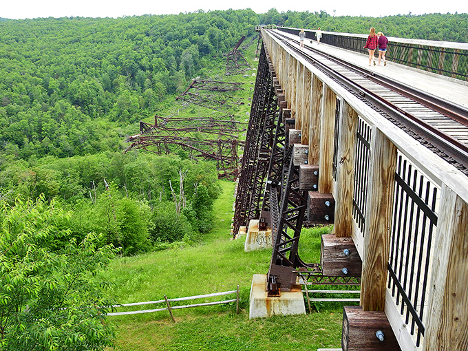 Visitors stroll along the remaining section of the once-mighty Kinzua Viaduct, now transformed into a pedestrian walkway with vertigo-inducing views below.
