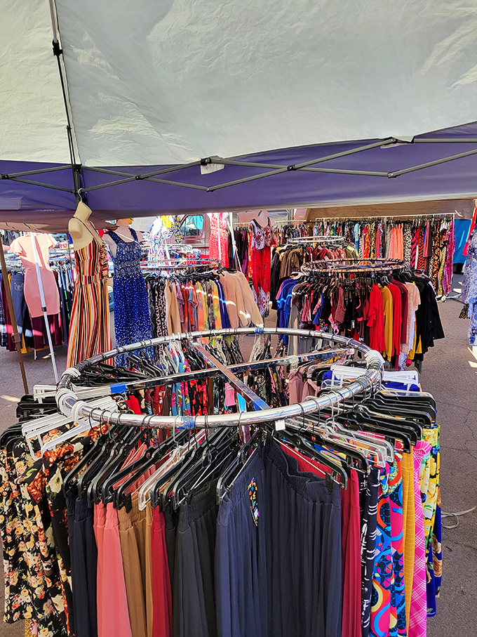 A circular rack of fashion possibilities spins like a wheel of fortune. Somewhere in this rainbow of fabrics lies your next favorite outfit.