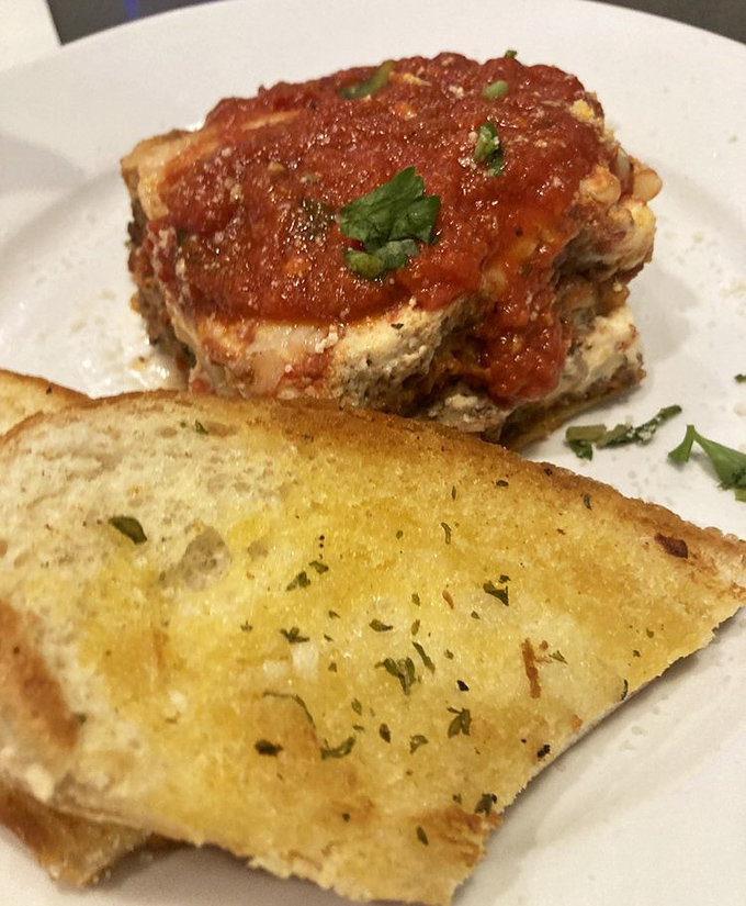 Lasagna that would make Italian grandmothers nod in approval, paired with garlic bread that transforms "I shouldn't" into "just one more piece."