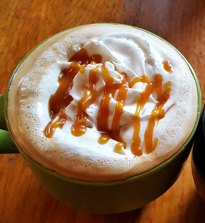 A latte that understands the assignment&mdash;foam art is nice, but that caramel drizzle is performing the real magic here. 