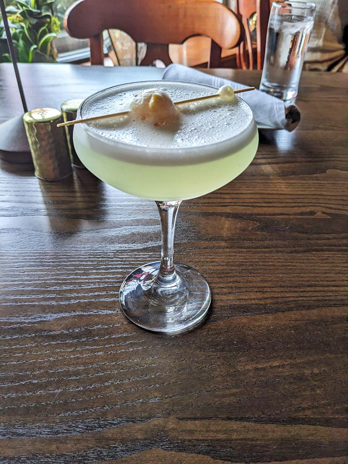 This cocktail isn't merely served &ndash; it's presented with the kind of foam cap and garnish that makes you pause to take a photo before the first sip.