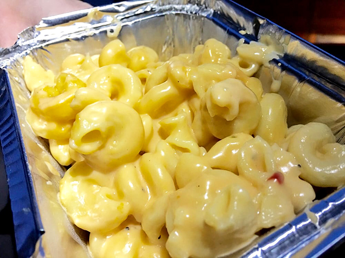 Mac and cheese that doesn't know it's a side dish. Creamy, dreamy, and unapologetically indulgent – comfort in a foil container.
