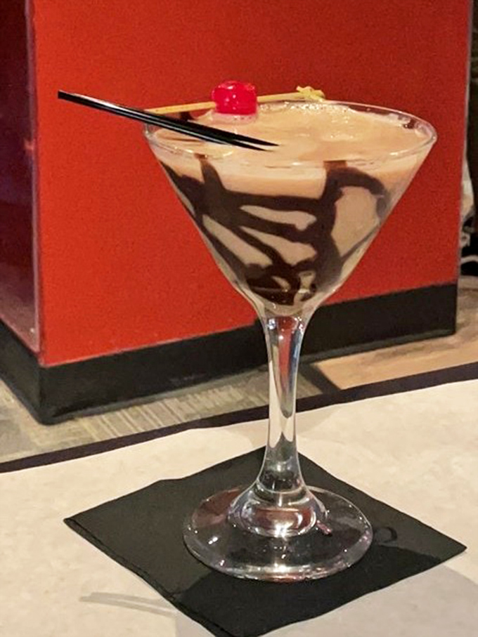 A martini that belongs in the Louvre. The chocolate swirl transforms this cocktail into drinkable art with a cherry on top.