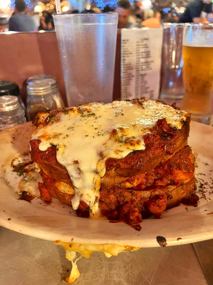 This isn't just a sandwich; it's an architectural marvel of bread, meat, and sauce that requires both hands and zero shame.