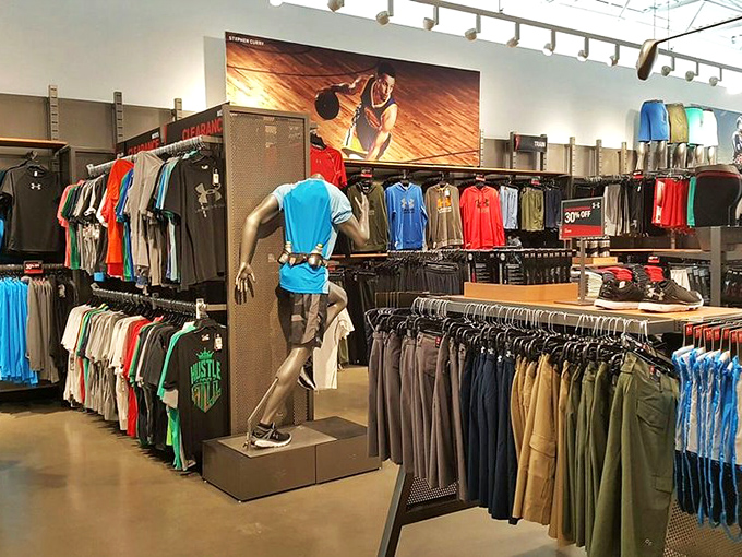 Mannequins dressed better than most of us stand guard over color-coordinated clothing kingdoms, silently judging our fashion choices.