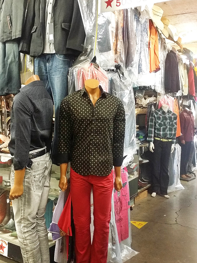 The mannequins sport outfits with more personality than most runway shows, including this bold pattern-meets-red-pants combo that demands confidence.