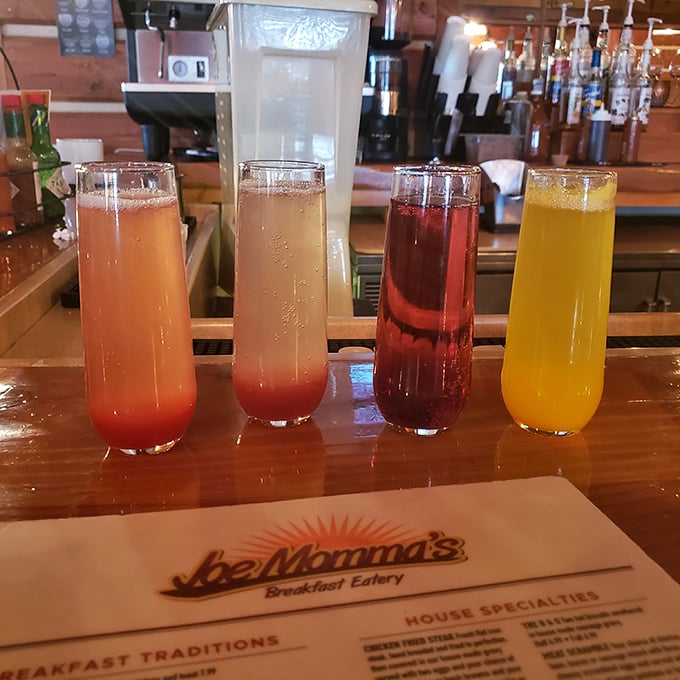 Four mimosas lined up like liquid sunshine, because sometimes Tuesday morning needs a little champagne therapy.