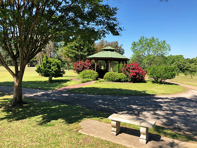 Mineola Country Club's gazebo provides a serene oasis amid manicured grounds, where golfers pause between holes to appreciate East Texas' natural splendor.