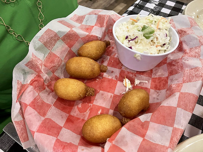 These mini corn dogs nestled beside creamy coleslaw remind us that sometimes the best things come in small, golden-fried packages.