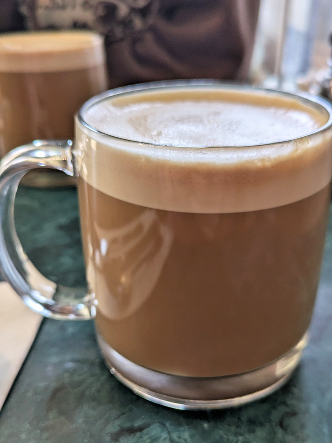 This isn't just coffee—it's a mocha latte that doubles as therapy in a glass mug. The foam alone deserves a standing ovation.