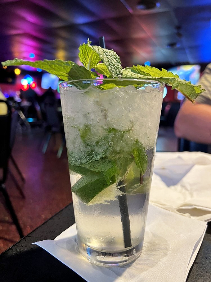A mojito garnished with enough fresh mint to start a small garden—refreshing enough to make you forget you're in Ohio, not Miami.
