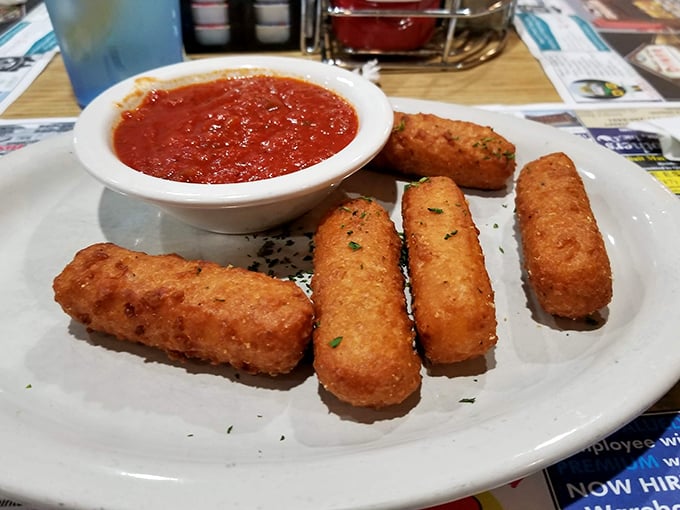 Mozzarella sticks&mdash;golden-brown on the outside, molten cheese within&mdash;served with marinara for dipping. The universal language of appetizer happiness.