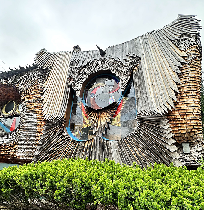 The undulating wooden shingles create a textural masterpiece, proving that sometimes the most interesting architecture grows from the wildest imaginations.