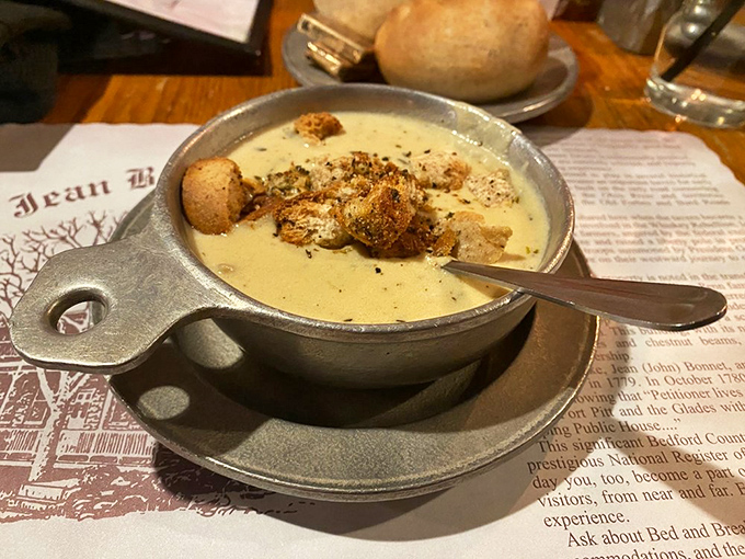This soup isn't just served—it's presented like liquid gold in a vessel that's seen more presidential administrations than the White House china.