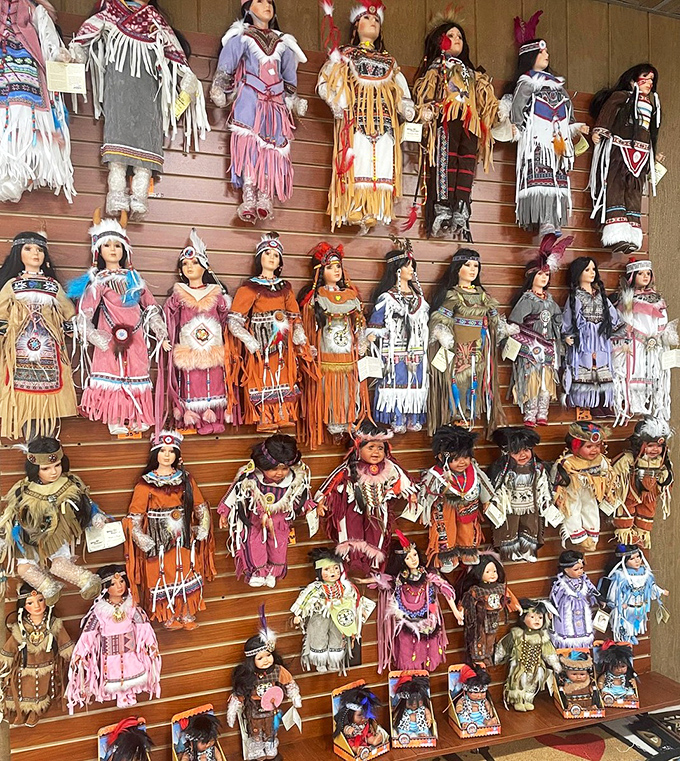 Native American dolls line the shelves in traditional attire. A colorful cultural display that adds Southwestern authenticity to your souvenir hunting.