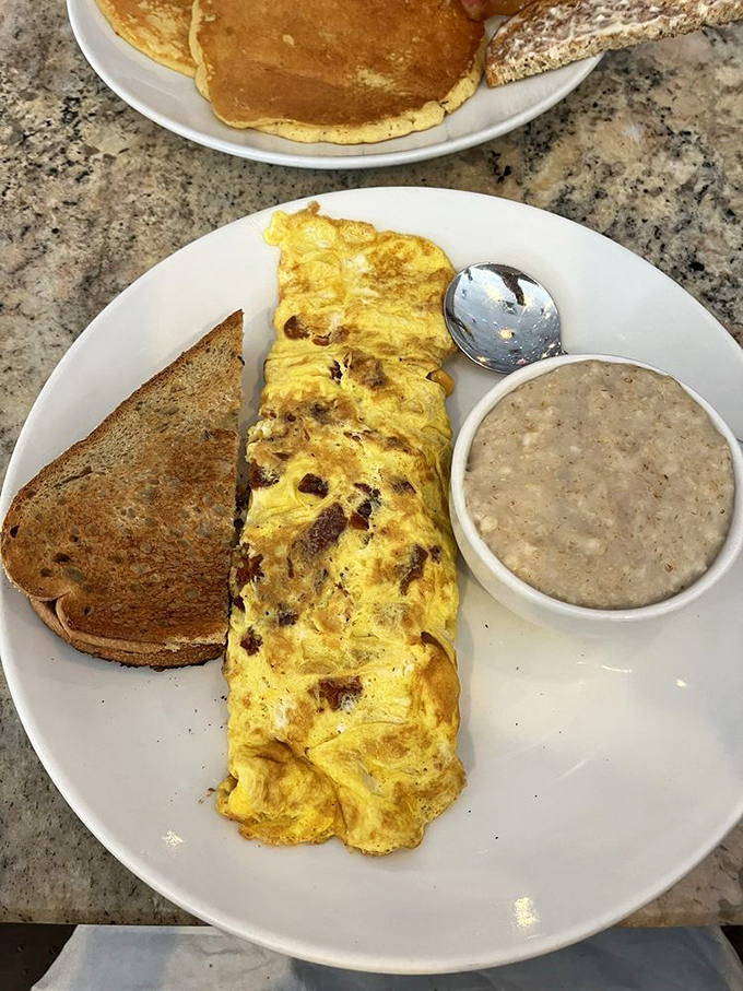 An omelet that's seen things, done things, and has stories to tell – all while keeping company with toast and grits.