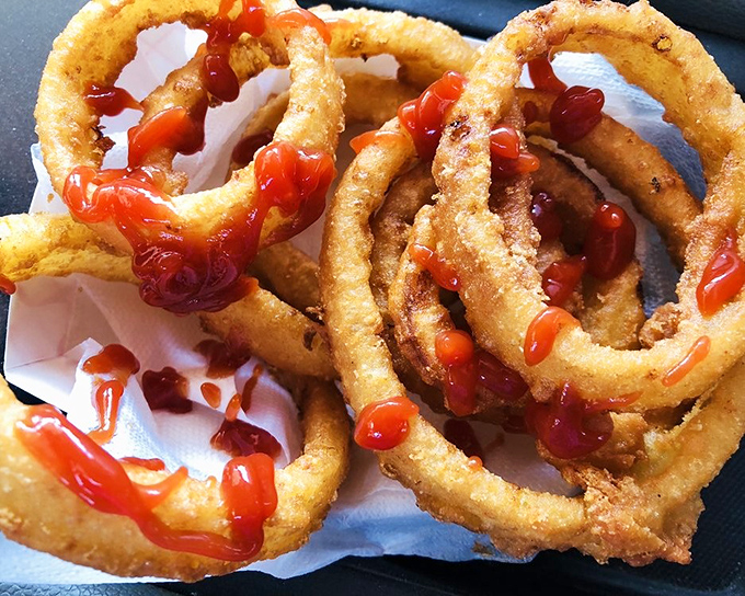 Onion rings with the perfect crunch-to-onion ratio, drizzled with ketchup&mdash;proof that sometimes the side dish deserves to be the main attraction.