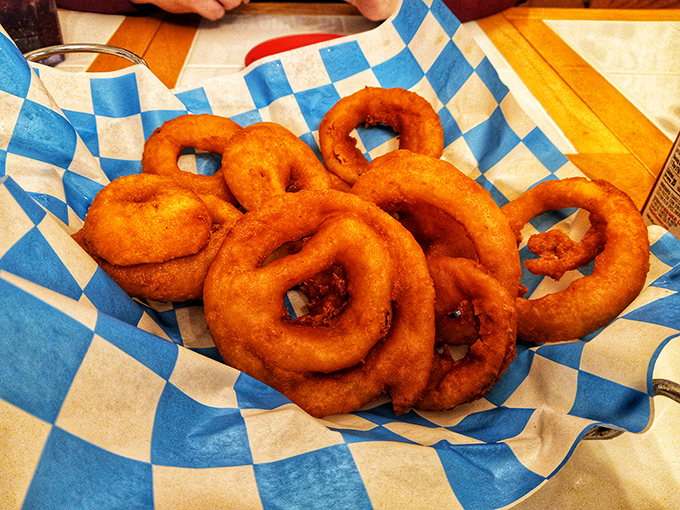 These aren't just onion rings&mdash;they're golden halos of happiness, perfectly crisp and served on that signature blue-checkered paper that screams "hometown diner."