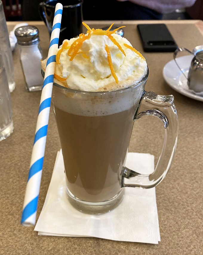 Not just a coffee, but a dessert masquerading as a morning beverage, complete with a whipped cream hat and citrus accessories.