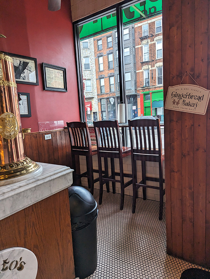 A window seat with a view of urban life. These wooden chairs have witnessed countless conversations fueled by good food and better company.