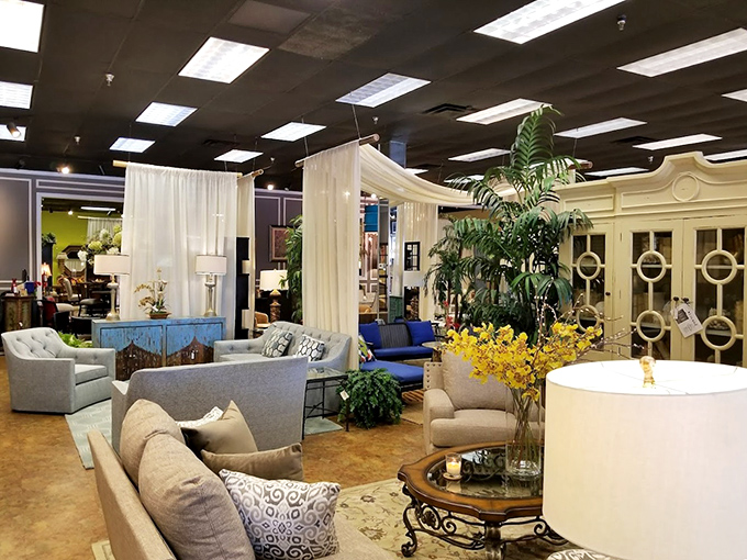 Flowing white curtains create room dividers that transform this retail space into a series of intimate home settings.