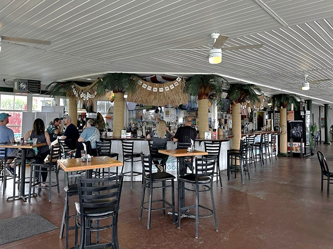 The tropical-themed bar area channels vacation vibes year-round, where palm decorations and cold drinks make Monday feel like Saturday.