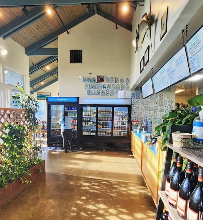 The beverage coolers and wooden accents create that perfect balance between fish market functionality and restaurant comfort. No pretension, just purpose.