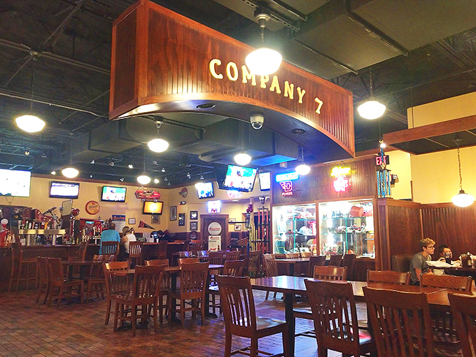 The wooden "Company 7" sign watches over diners like a benevolent BBQ deity. This isn't just eating&mdash;it's a communal experience with TVs for company.