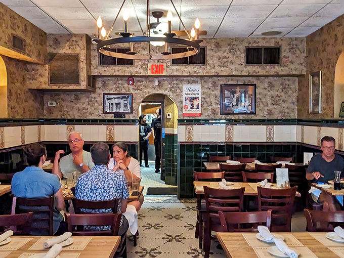 Floral wallpaper and vintage photographs create an atmosphere that's both elegant and homey. Dining here feels like being welcomed into someone's cherished family room.