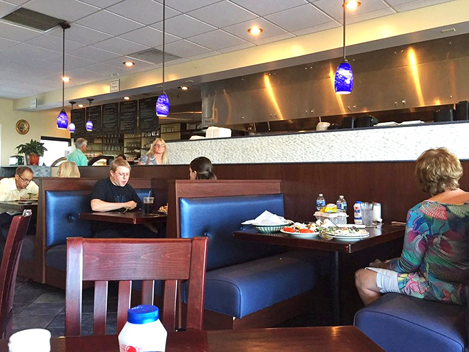 Where blue meets comfort. The thoughtful layout combines booth seating with traditional tables, creating the perfect backdrop for Greek feasting.