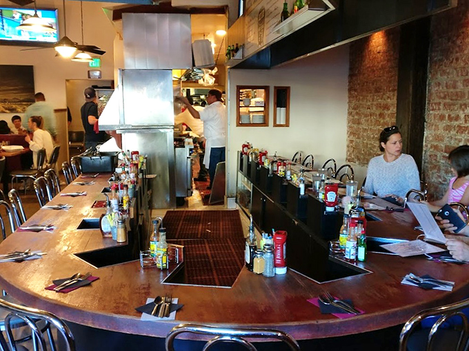 The counter seating offers front-row tickets to the breakfast show. Those condiment bottles aren't decorative&mdash;they're essential supporting actors.